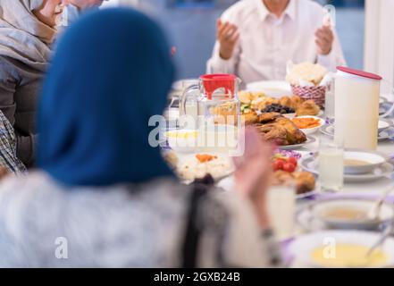Happy multiethnic family praying before meal at home together. People ...