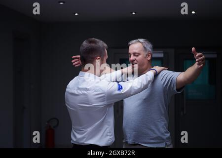 Security guard making body searching procedure with a metal detector on ...