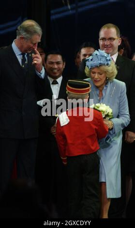 Queen Camilla receives a bouquet of flowers as she leaves after opening ...