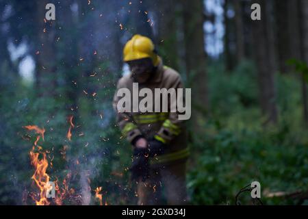 firefighter hero in action danger jumping over fire flame to rescue and ...