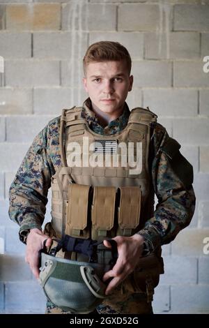 Soldier preparing tactical protective and communication gear for action ...