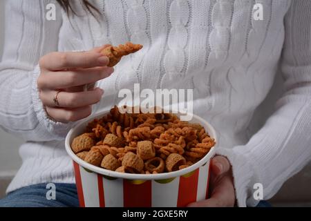 A bowl of Israeli Bissli wheat snacks with different flavors and shapes ...