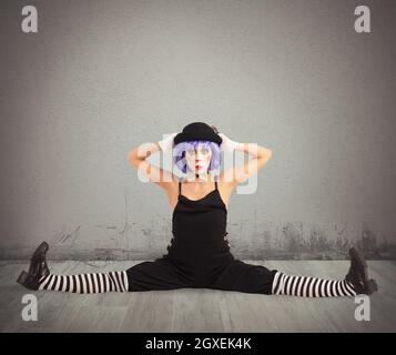 Funny clown dancer makes a big split Stock Photo - Alamy