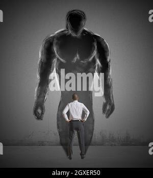 Successful businessman with strong shadow Stock Photo - Alamy