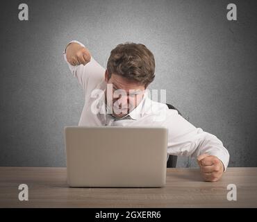 Stressed businessman breaks the computer with punch Stock Photo - Alamy