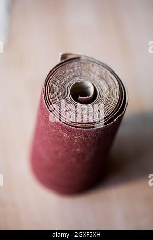 Close up shot of a sandpaper roll on a wooden table Stock Photo - Alamy