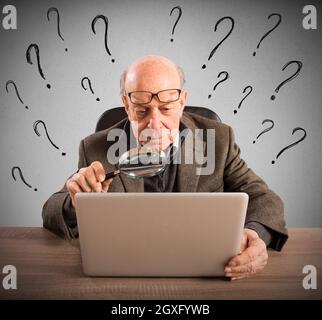 Confused elderly man looks at the computer Stock Photo - Alamy