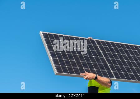 Unidentified man attaching solar panel to the roof rack with the ...