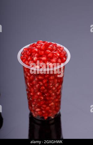 Fresh Pomegranate seed arranged in a square glass container with fresh ...