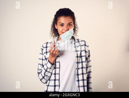 Woman removes the face mask. concept of pandemic of covid-19 Stock ...