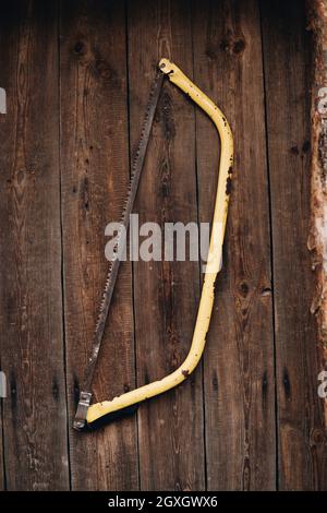 detail of old metal saw hanging in front of wooden wall Stock Photo - Alamy