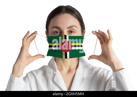 Respirator with flag of Dominica Doctor puts on medical face mask ...
