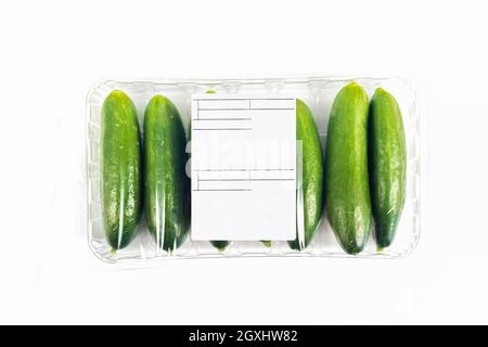 Freshly harvested mini cucumber with package and label on white ...
