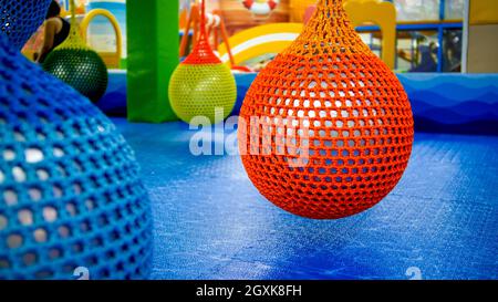 Colorful inflatable balls in nets hanging at gym. Colorful inflatable ...