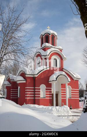 Beautiful snowed red church in the winter, blue sky Stock Photo - Alamy