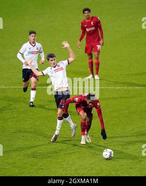 Bolton Wanderers' George Thomason (right) shots wide of the goal during ...
