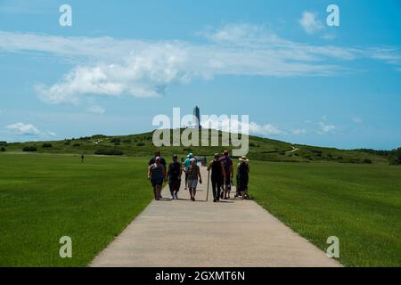Kitty Hawk, NC, USA -- July 27, 2021. Tourists in the distance head for ...