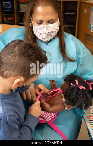 People wear face masks to help curb the spread of the coronavirus as ...