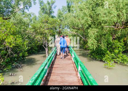 HIRON POINT, BANGLADESH - NOVEMBER 14, 2016: Tourists are leaving their boat at Hiron Point in ...
