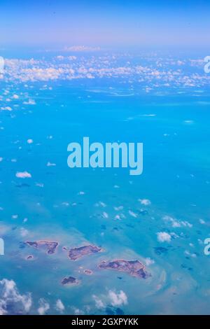 Aerial view of scattered islands with blue ocean water at Wajag Island ...
