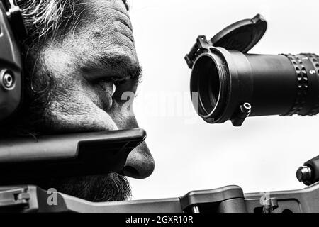 An Italian Special Forces Sniper looks downrage at his target during a ...
