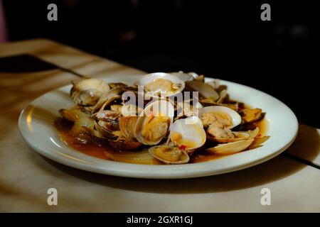 Chinese baby clams on the shell with black bean sauce Stock Photo - Alamy