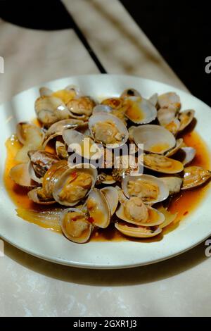 Chinese baby clams on the shell with black bean sauce Stock Photo - Alamy