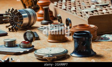 Assorted vintage tools on display on a clockmakers workbench Stock ...