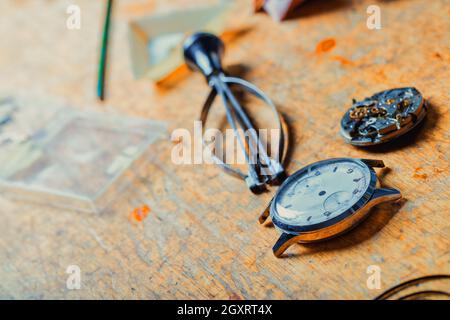 Wristwatch and loose mechanism lying on a watchmakers bench Stock Photo ...