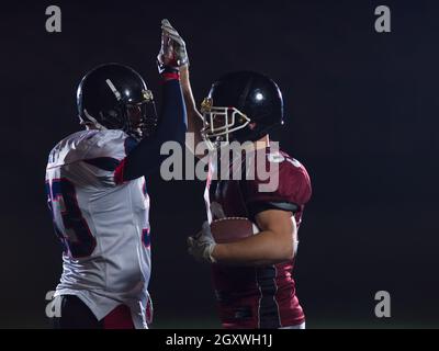Happy Football Players Giving High Five At Field. Soccer Players High ...