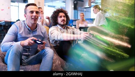 Work hard play hard. Office Workers Playing computer games Stock Photo ...