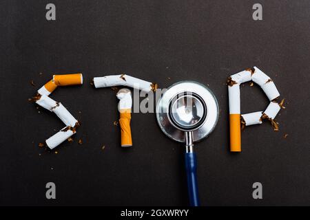 broken pile cigarette or tobacco on yellow background Stock Photo - Alamy