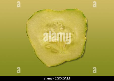 cucumber slice over matching colour gradient background with copy space ...