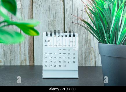 The June 2022 desk calendar with plant pot on wooden table Stock Photo ...