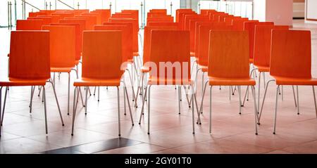 The Conference room with red chairs, concrete floor and windows ...