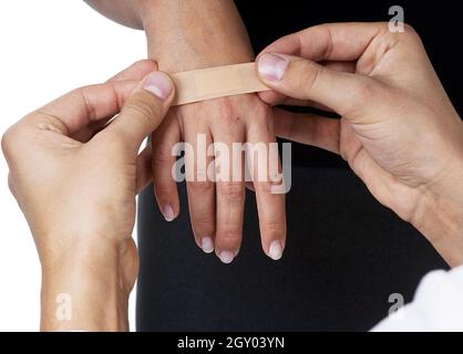 The doctor's hands are gluing a medical plaster on the released nucleus ...