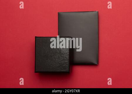 Red giftbox with black envelope card on black background, Black friday ...