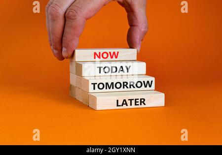 Act now, not later symbol. Male hand turns wooden cubes and changes ...