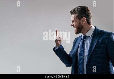 Angry broker man in formal wear sideway keep finger raised grey ...