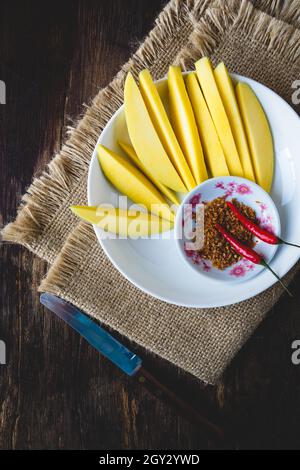 A top view of sliced mangoes on a brown table Stock Photo - Alamy