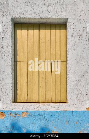 Mustard yellow facade window and antique wood Stock Photo - Alamy