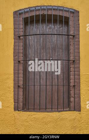Mustard yellow facade window and antique wood Stock Photo - Alamy