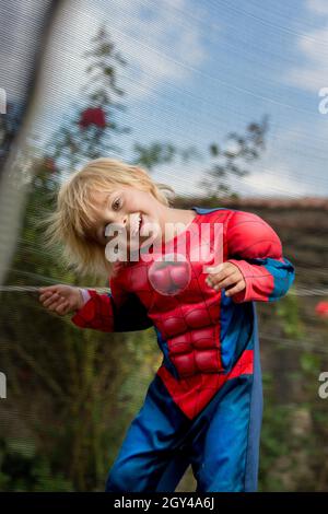 Child with static hair on trampoline in backlight Stock Photo - Alamy