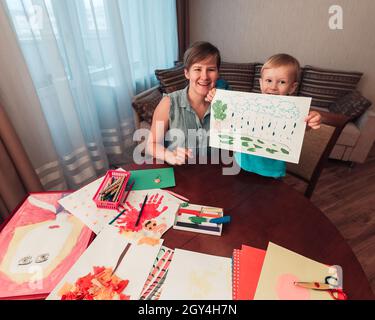 happy children draw together at the table Stock Photo - Alamy