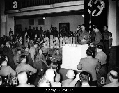 Adolf Hitler Speech, 1939 speaking under a large shining swastika ...