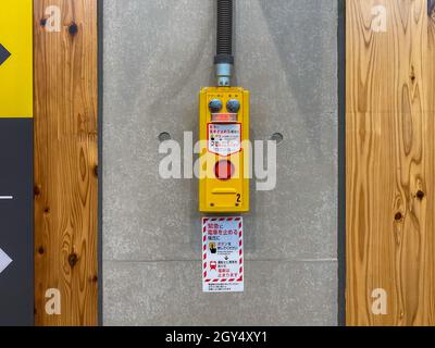 Emergency train stop button sign on the platform of a Japanese railway ...