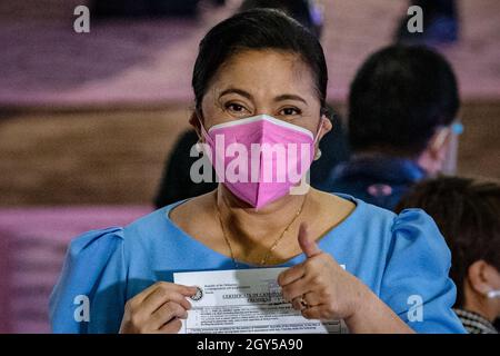 Philippine Vice President Maria Leonor "Leni" Robredo, center, leads ...