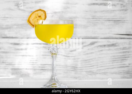 Glass of Yellow Submarine Cocktail garnished with slice of banana Stock ...