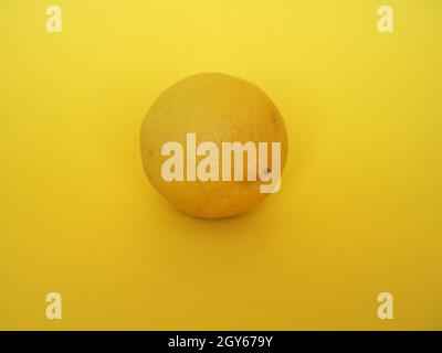 lemon fruit (scientific name Citrus limon) over yellow background Stock ...
