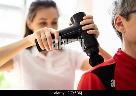 Massage Gun Shoulders Recovery Therapy Using Machine Stock Photo - Alamy
